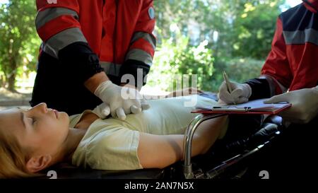 girl making cardiopulmonary resuscitation to an unconscious guy after ...