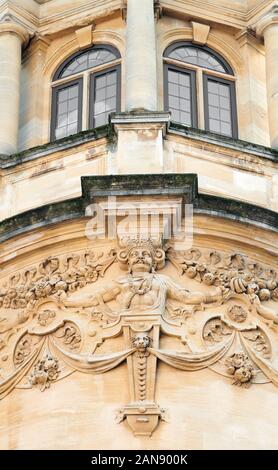 Hindu style stone sculptures on the stone wall of the cupola at the ...
