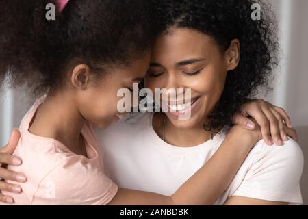 Happy black woman hugging her adopted child Stock Photo - Alamy
