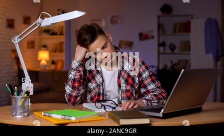 Student preparing for exams late at night in library Stock Photo - Alamy