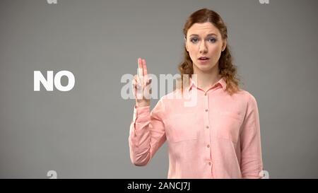 Deaf woman saying no in sign language, teacher showing words in asl ...