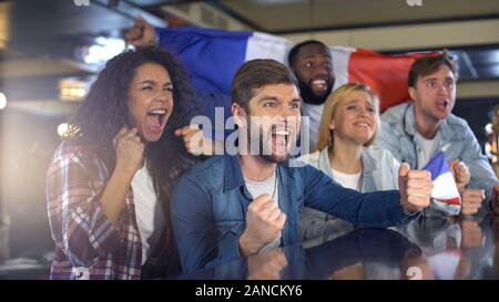 Excited football fans supporting French national team in live soccer ...