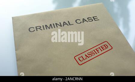 Criminal case, folder with important police documents lying on table ...