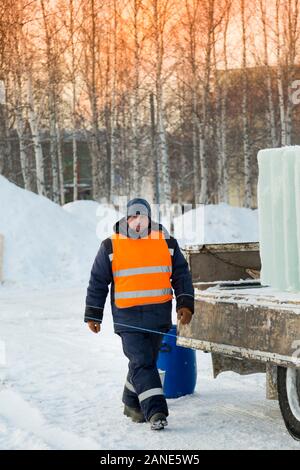 The installer at the construction site of the ice town covers the ...