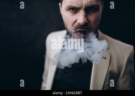 Angry mature man with aggressive look making silence sign in ...