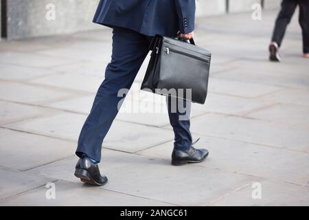 elegant businessman in black suit smelling red rose isolated on grey ...