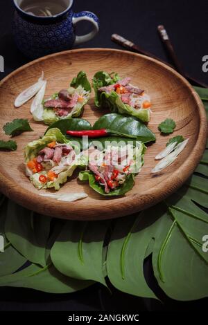 Spicy thai beef and lettuce canape with glass noodles Stock Photo - Alamy