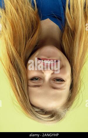 Looks happy, smiling. Inverted portrait of caucasian young man on ...