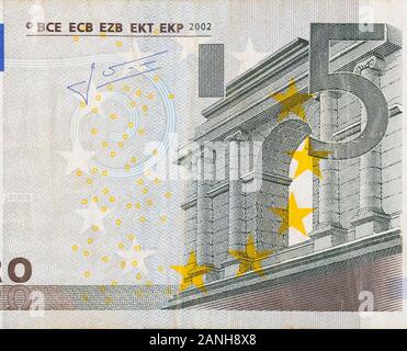 Fragment part of 5 euro banknote close-up with small brown details ...