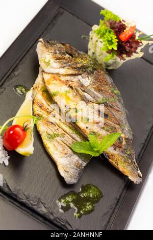 Hot grilled mullet on a plate on lettuce leaves Stock Photo - Alamy
