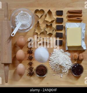 Tasty Christmas cookies, cutters and ingredients on color background ...