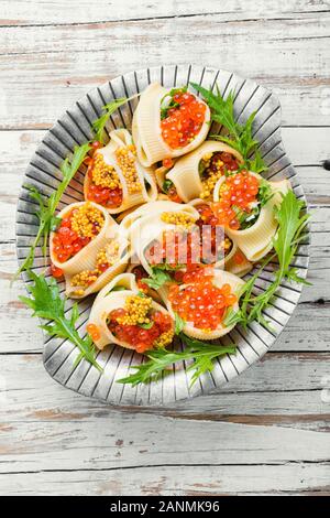 Festive, banquet pasta dish stuffed with red caviar.Macaroni stuffed ...