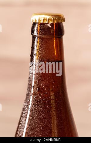 a bottle of amber beer with its capsule Stock Photo - Alamy