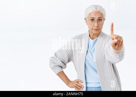 Senior displeased man shaking his finger and looking at camera isolated ...