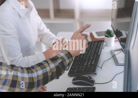 Pensive programmer working on on desktop pc programming code technologies or website design at ...