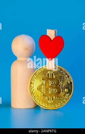 Human figurine, bitcoin coin and heart on a blue background. love for ...