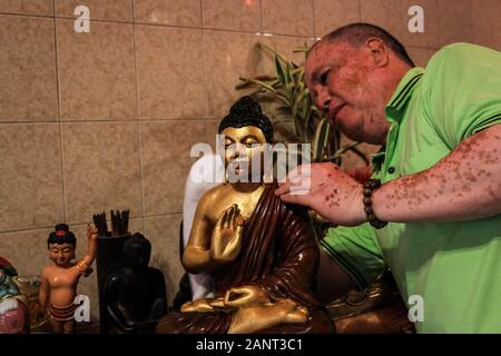 A man clean a statue during the celebration at Dharma Ramsi temple in ...