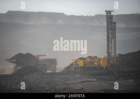Drilling machine borer installing cast explosives blasting. Open coal ...