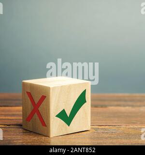 Wooden block with a green check mark and red cross x, choice and ...