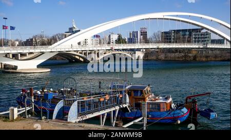 Barges laying at quay along the Rhone river bank at foot of Confluences ...