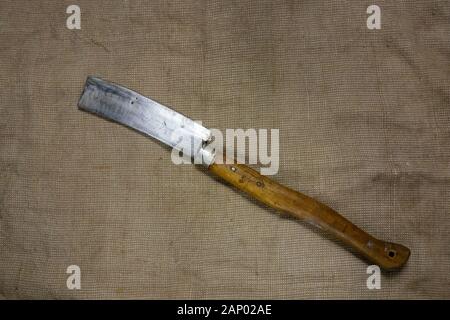 Big butcher knife on bagging fabric background. Closeup view of weapon ...