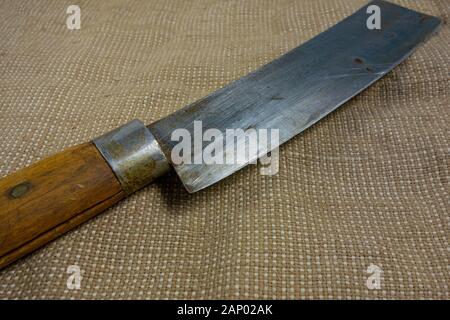 Big butcher knife on bagging fabric background. Closeup view of weapon ...