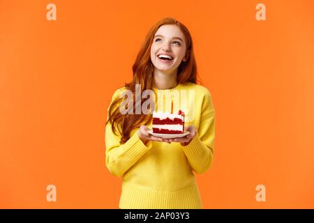 Dreamy happy girl celebrating birthday, having fun, laughing and gazing ...