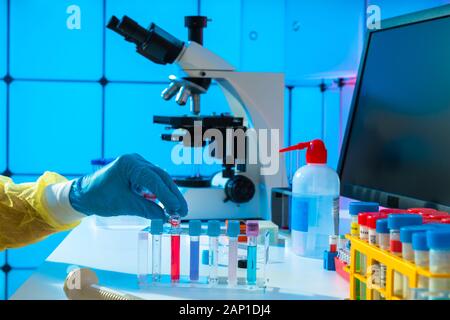 Scientific experiment in microbiological lab. Microscope and test tube ...