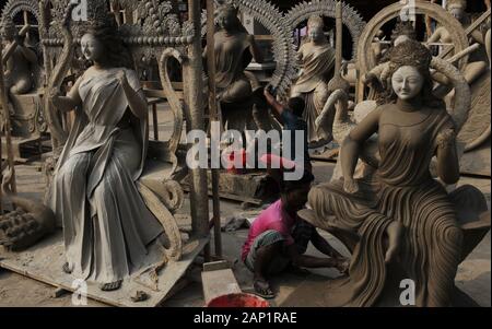 Clay idol of Goddess Saraswati in a garage turned makeshift decorative ...