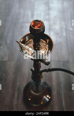 hot red coals hookah with sparks in the tweezers for Smoking on a dark ...