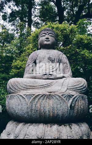 Buddhist statue zen resting on top of cement block Stock Photo - Alamy