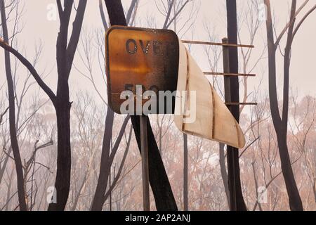 Burning road sign in a bushfire on the main road 251, NP Chapada dos ...