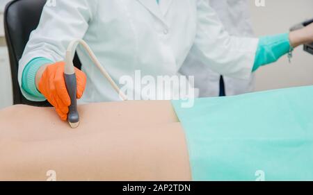 Legs ultrasound examination scan for woman. Vascular surgeon examines ...