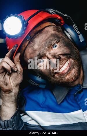 Miner happy man smiling after working on coal mine. Concept industrial ...