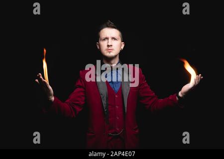 Magician shows trick with fire burn from palms hands Stock Photo - Alamy