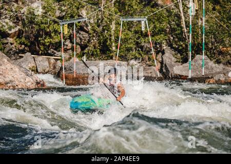 Guy in kayak sails mountain river. Whitewater kayaking, extreme sport ...