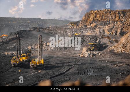 Drilling machine borer installing cast explosives blasting. Open coal ...