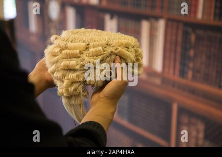 A wig being held, as worn by some judges and barristers in England and ...