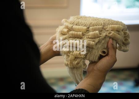 A wig being held, as worn by some judges and barristers in England and ...