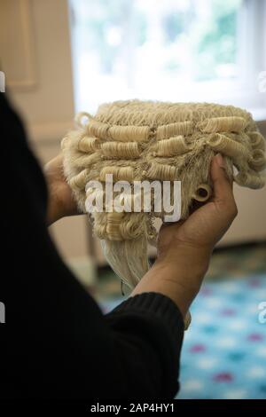 A wig being held, as worn by some judges and barristers in England and ...