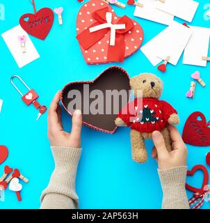 Hand holding a red clothespin on a white background Stock Photo - Alamy