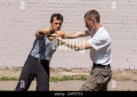 Defender defends itself from the attacker with a gun. Self Defense ...