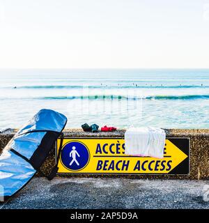 Beach access sign and surfboard Stock Photo - Alamy