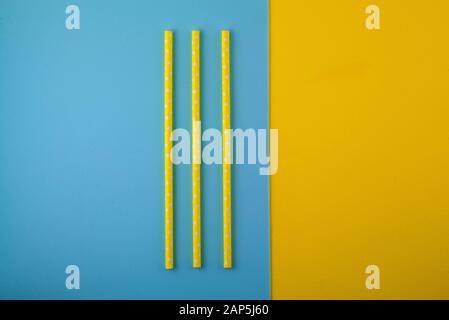 A closeup of paper straws on a yellow background Stock Photo - Alamy