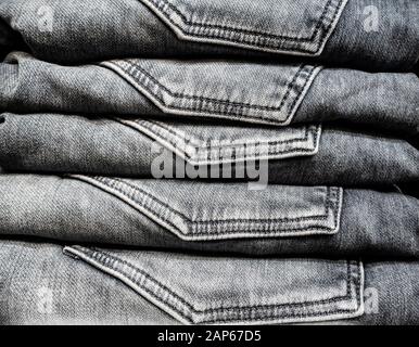 Jeans neatly folded in a pile on a wooden shelf. Flatley. Concept of ...