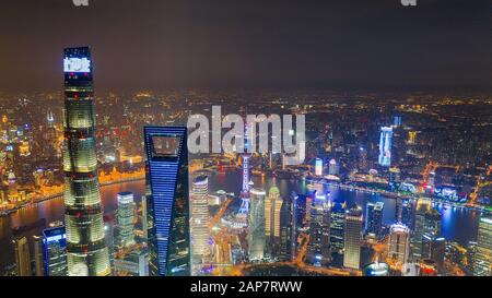 aerial view of Shanghai towers and tall buildings lighted up at night ...