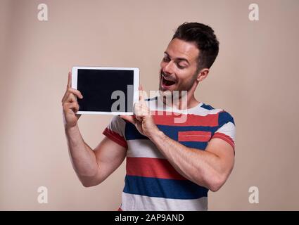 Man scream of joy and happiness, showing big red heart cutout on ...