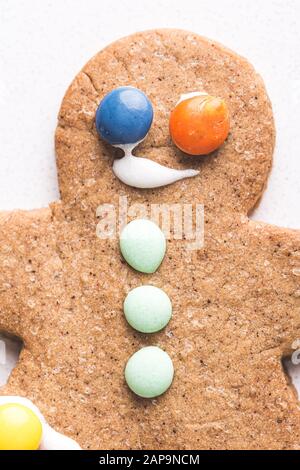 Artisan handmade gingerbread human shape cookie on a white background ...