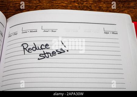 Reduce stress, handwriting text on page of office agenda. Copy space ...