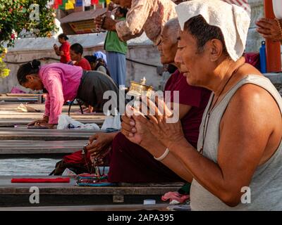 Buddhist Tibetan woman prostrating Nepal Stock Photo - Alamy
